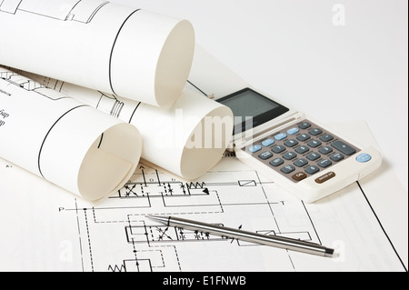 rolled technical drawings and a calculator Stock Photo - Alamy