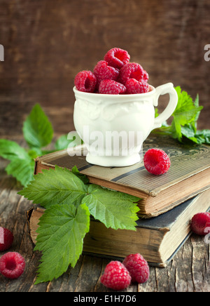 Fresh raspberries in cup Stock Photo - Alamy
