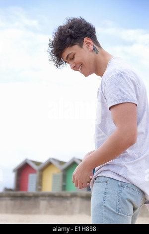 Ethnic man in shirt and trousers with Afro hairstyle standing against ...