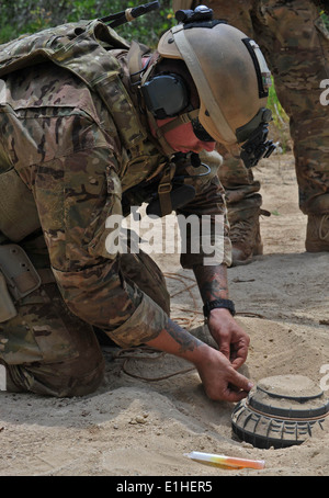 A U.S. Army EOD Technician from 53rd Ordnance Company (EOD) clears a ...