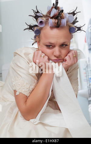 Frustrated bride with curlers sitting on toilet Stock Photo - Alamy