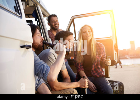 Happy friends celebrating at minivan Stock Photo - Alamy