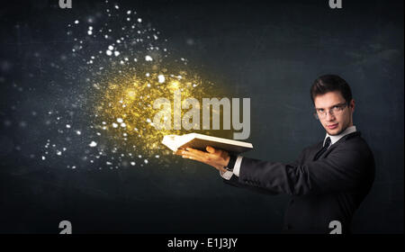 Young guy reading a magical book Stock Photo - Alamy
