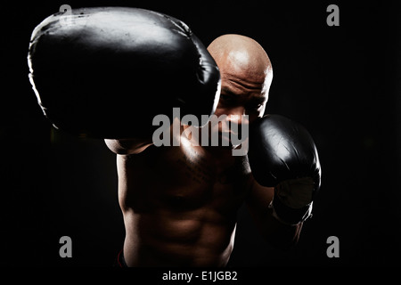 Punch towards camera by black boxer outdoors Stock Photo - Alamy