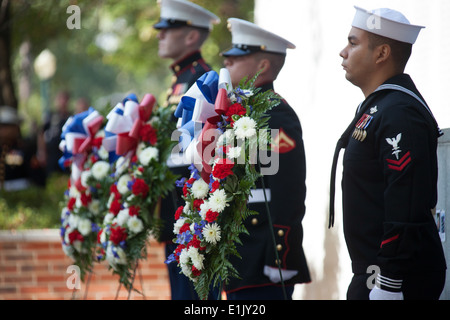 The U.S. Navy Sailors and Marines stand at parade rest while manning ...