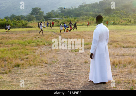 Catholic priest watching a soccer game Stock Photo - Alamy