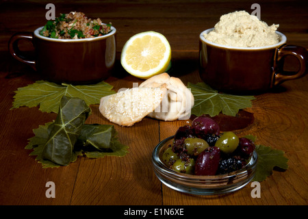 Middle Eastern appetizer spread including tabbouleh, hummus, dolma ...
