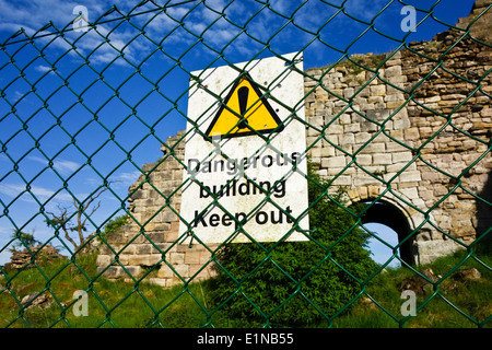 Fence around historic ruin Dangerous building keep out sign Stock Photo ...
