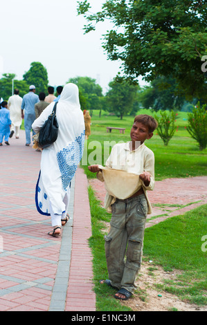 Muslim child in white traditional clothes, saying message on megaphone ...