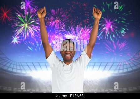 Composite image of excited handsome football fan cheering Stock Photo ...