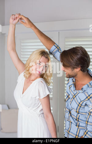 Cute young couple dancing at home Stock Photo - Alamy