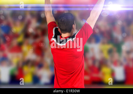 Composite image of excited football player cheering Stock Photo - Alamy