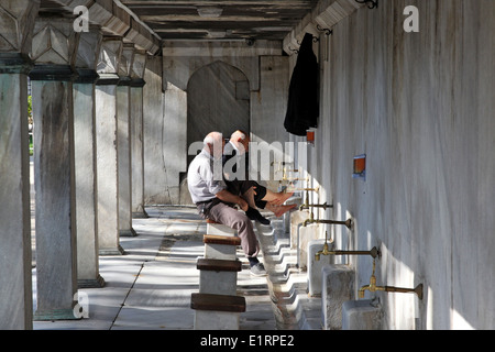 muslim men washing their feet before entering the Blue mosque for ...
