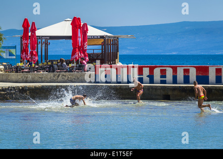 young men are playing picigin in bacvice split croatia. picigin is a ...