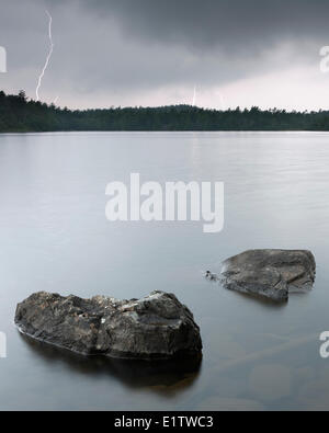 LIghtning Strikes over rocks and water Stock Photo - Alamy