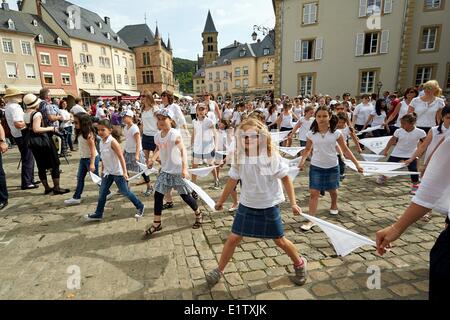Participants in the dancing procession of Echternach hop in rows ...