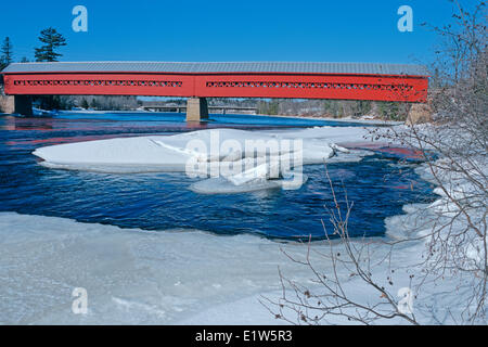 Red covered bridge over the Gatineau River, Wakefield, Quebec, Canada ...