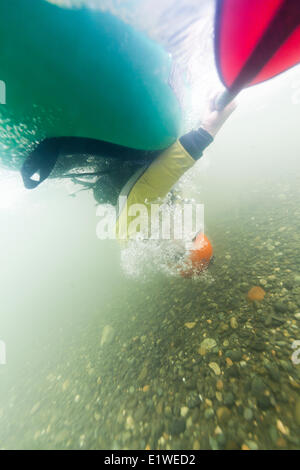 A man performs an eskimo roll in his sea kayak near Thief Island on ...