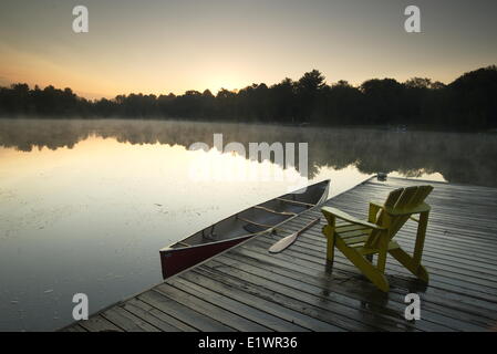 Canoe and Muskoka Chair at the dock in Muskoka, Ontario Stock Photo - Alamy
