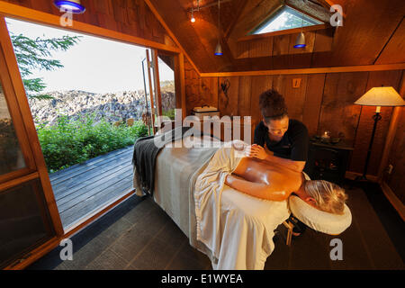 Two women massaging their calm client in massage salon Stock Photo - Alamy