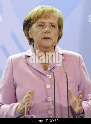 German Chancellor Angela Merkel answers a reporter's question as she ...