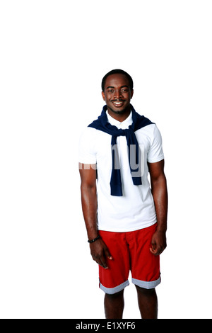 Portrait of smiling man standing by gray wall with arms crossed Stock ...