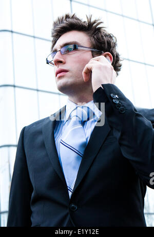 Businessman speaking over mobile phone Stock Photo - Alamy