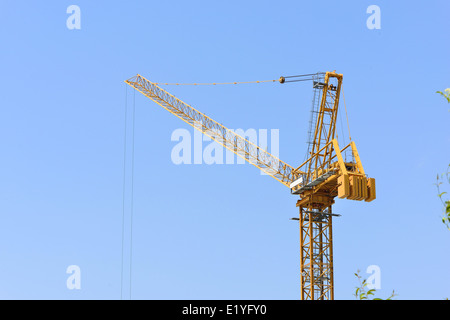 yellow tower crane in a construction site Stock Photo - Alamy