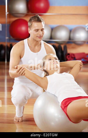 Sporty young woman training with fitball at home Stock Photo - Alamy