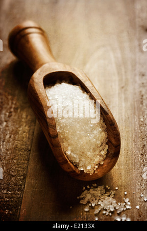 Sea salt poured from wooden scoop with clipping path Stock Photo - Alamy