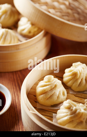 Baozi chinese dumplings on bamboo steamer Stock Photo - Alamy