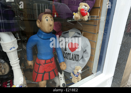 A model of comic book character Tintin dressed in a kilt beside ...