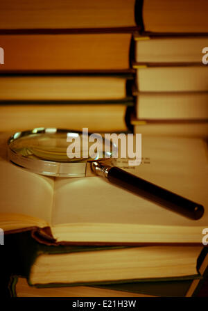 Ancient old books and magnifying glass Stock Photo - Alamy