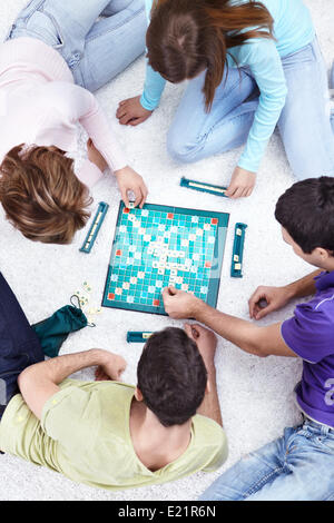 Four young people playing scrabble Stock Photo - Alamy