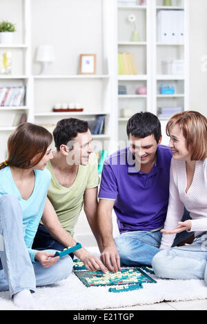 Four young people playing scrabble Stock Photo - Alamy