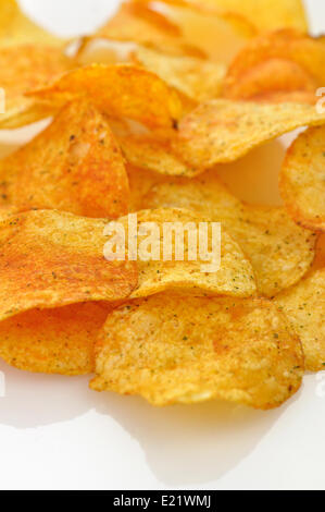 Paprika-flavored potato chips and fresh bell peppers isolated on white ...