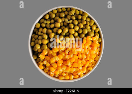 a plate with corn and peas, isolated, on a red background Stock Photo ...
