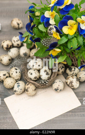 Easter greeting card with quail eggs in nest on wooden background. flat ...