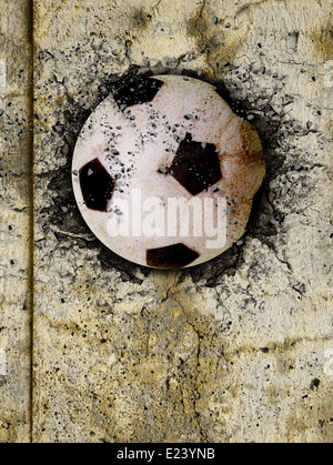 a soccer ball destroy a brick wall Stock Photo - Alamy