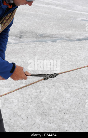 A mountain guide demonstrates making a prusik knot and how to set up a ...