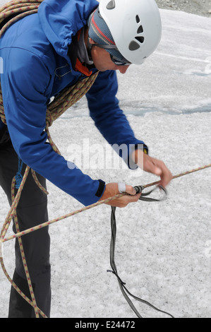 A mountain guide demonstrates making a prusik knot and how to set up a ...