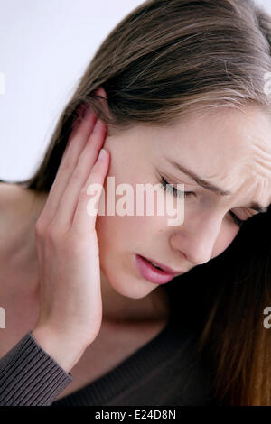 Close-up of the ear in a 2 year old female patient, showing melted wax ...