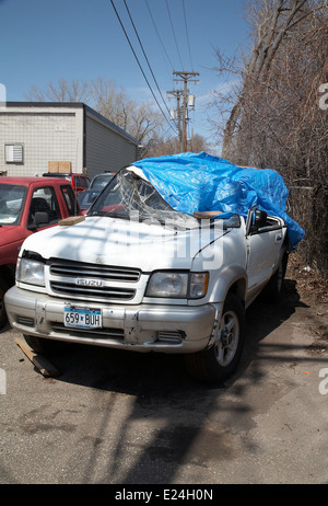 A smashed up white Isuzu trooper that has been in an accident in Stock ...