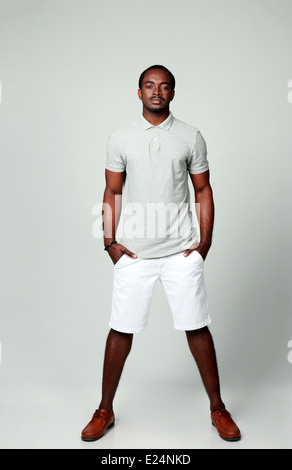 Full length portrait of a pensive african man on gray background Stock ...