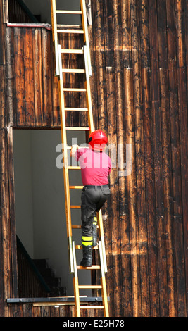 Fireman climbing a ladder during training drill Stock Photo - Alamy