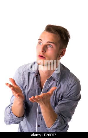 Needy, desperate young man pleading with hands joined as if praying to ...