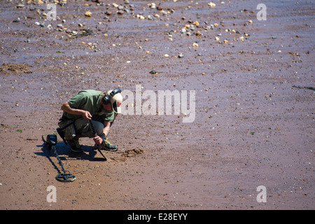 Man,digs,digging,in,sand,muddy,mud,mudflats,,sandy,area,of,Ferryside ...