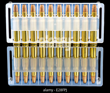 Rifle bullets in a plastic holder, placed on a leather bag, showcasing ...