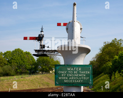 Signals and an engine water sign on a railway Stock Photo - Alamy