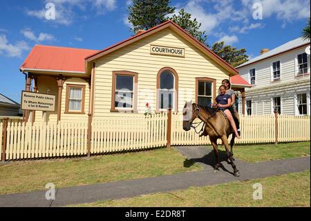 Rawene, North Island, New Zealand, June 20 2021: A rainbow brightens up ...